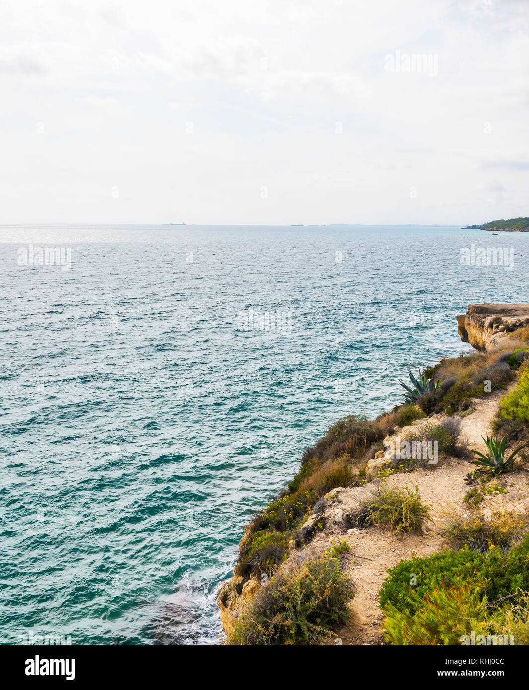high cliff above the sea, summer sea background, many splashing waves ...