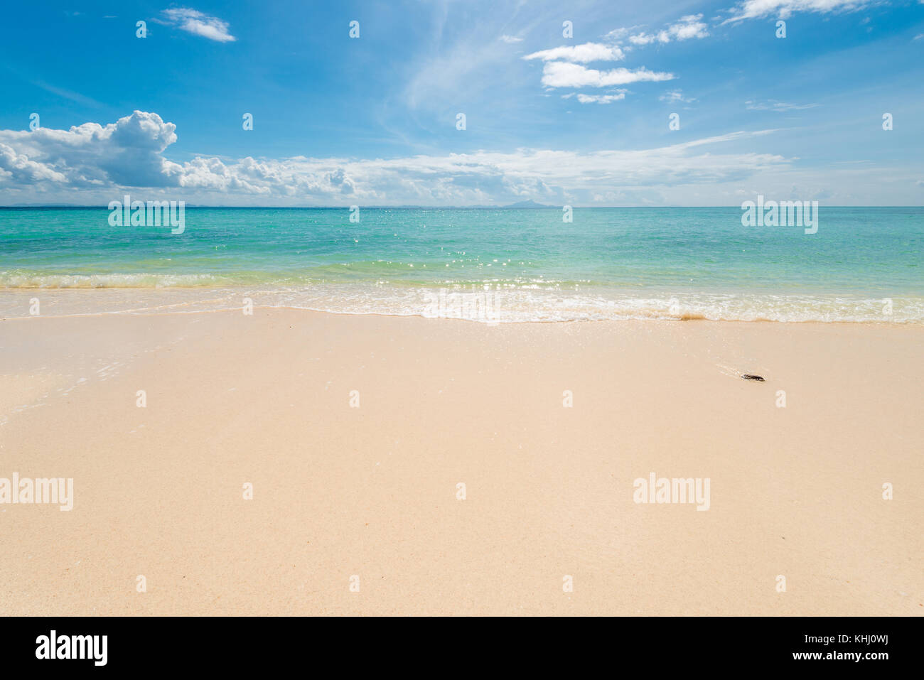 fine sand on the beach, calm azure sea and beautiful clouds on a sunny ...