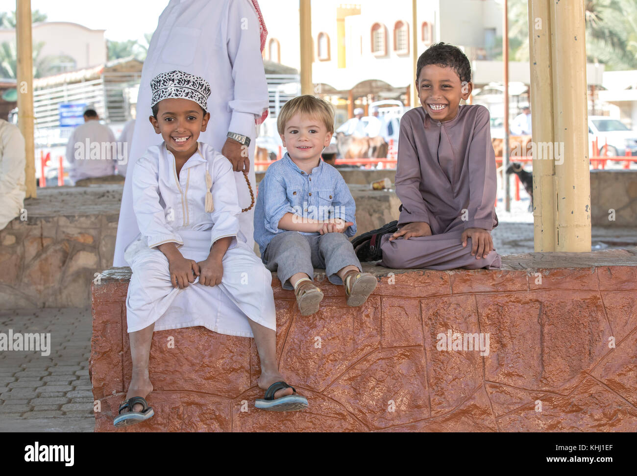 Nizwa, Oman, 10th Nobember 2017: omani kid and european kid shaking ...