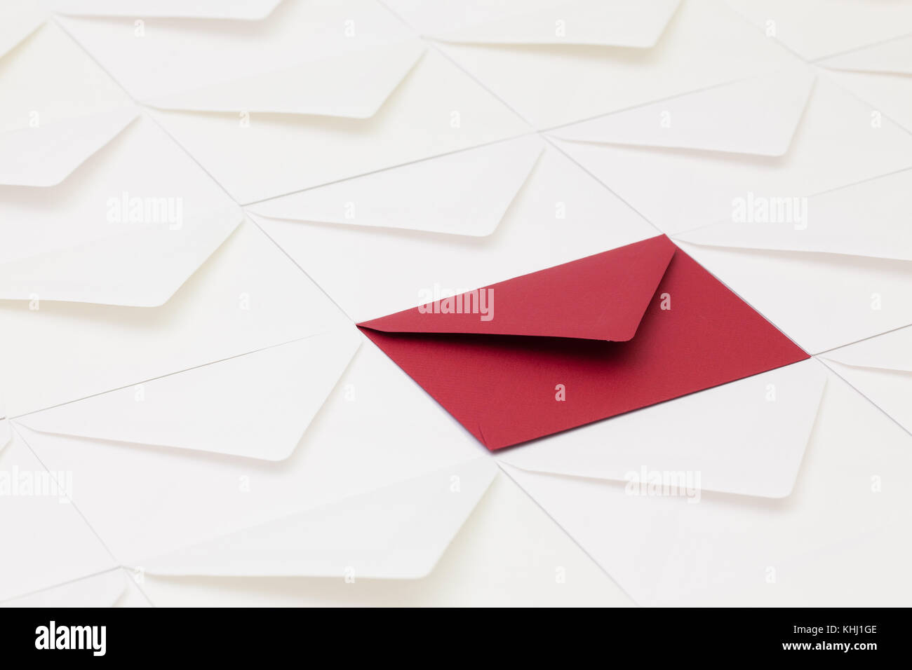 Composition with white envelopes and one dark red envelope on the table ...