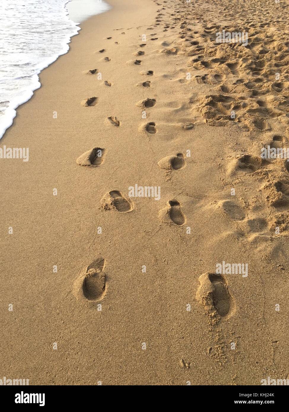 Foot imprints on a sandy beach in the morning Stock Photo - Alamy