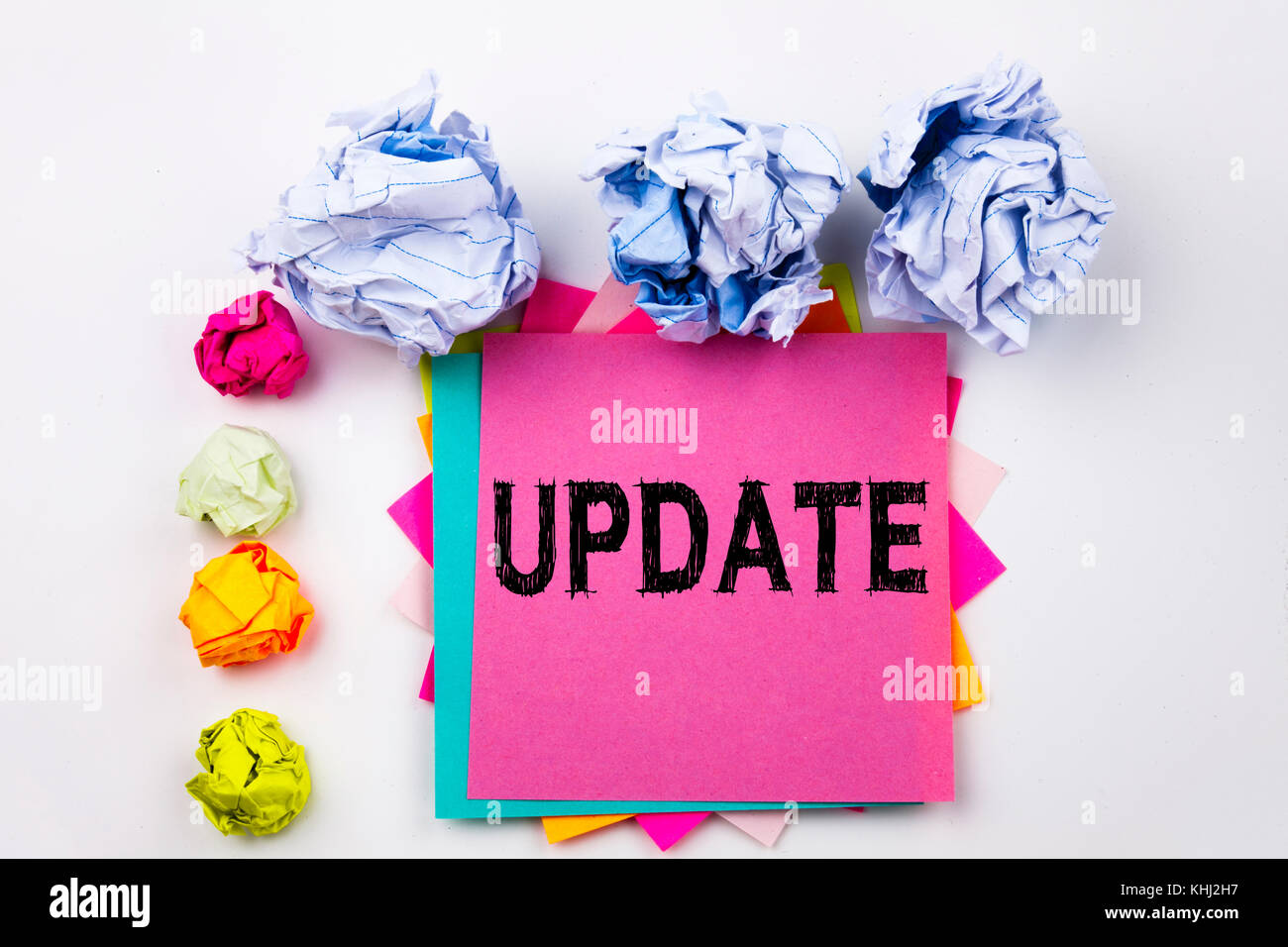 Writing text showing Update written on sticky note in office with screw ...