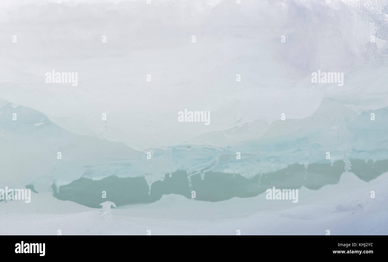 Transparent blue ice hummocks on lake Baikal shore. Siberia winter blur ...