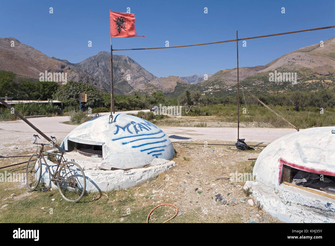Cold War bunker supporting a structure beside a beachside cafe in Borsh ...