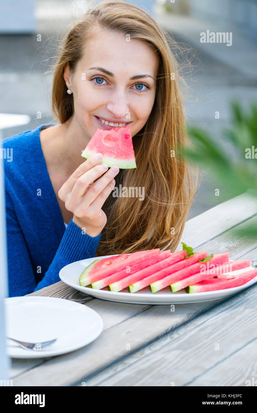 Young woman eating watermelon Stock Photo - Alamy