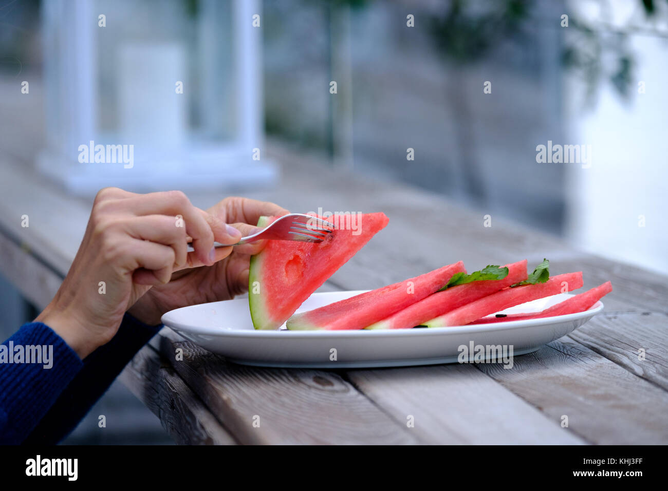 Young woman eating watermelon Stock Photo - Alamy