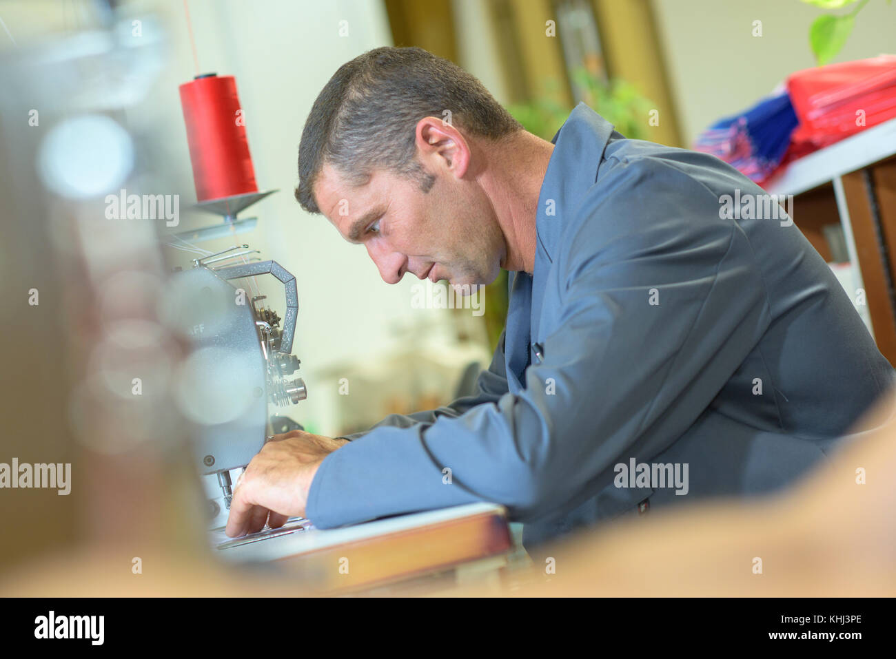 Man using sewing machine Stock Photo - Alamy
