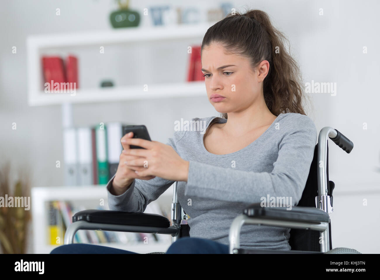 disabled woman in wheelchair on mobile phone Stock Photo - Alamy