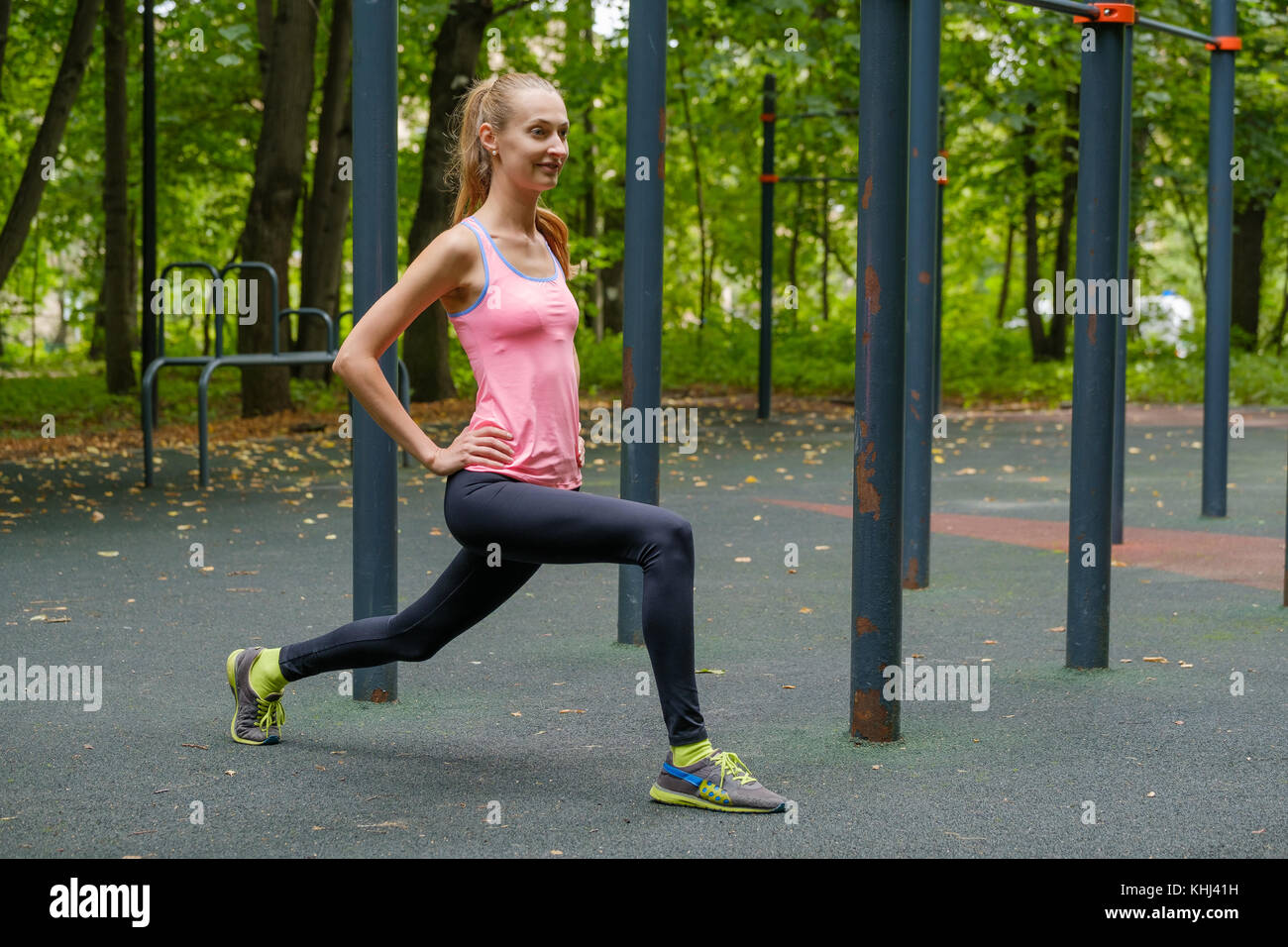 Young slim woman doing workout on training ground Stock Photo - Alamy