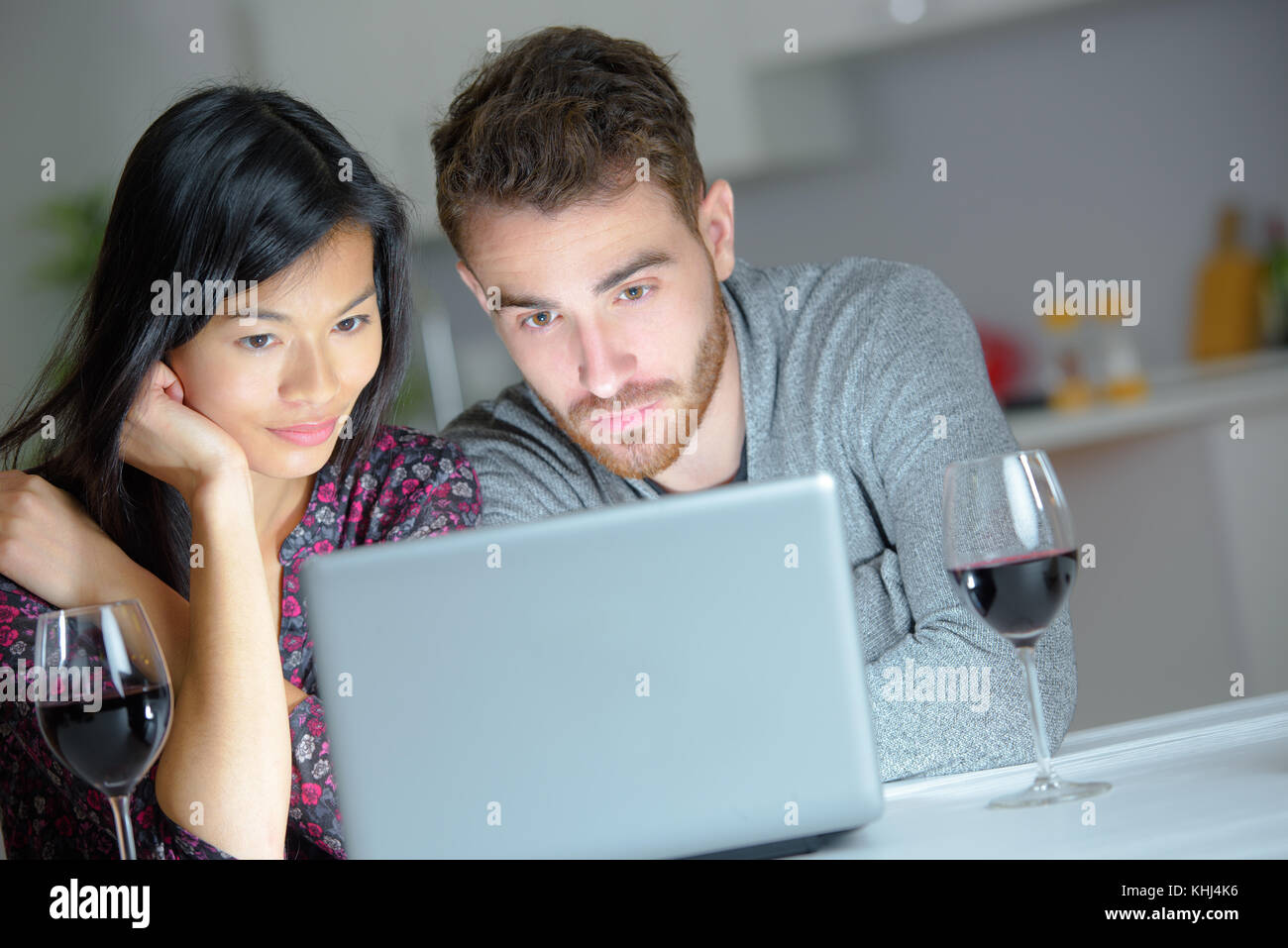 Drinking wine by the laptop Stock Photo - Alamy