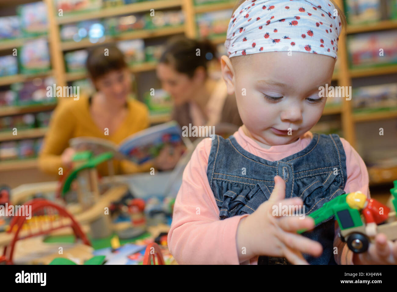 happy little girl having fun at toy store Stock Photo - Alamy
