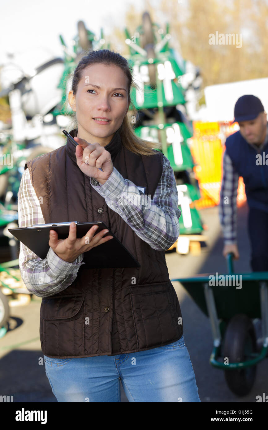 Lady with clipboard counting stock Stock Photo - Alamy