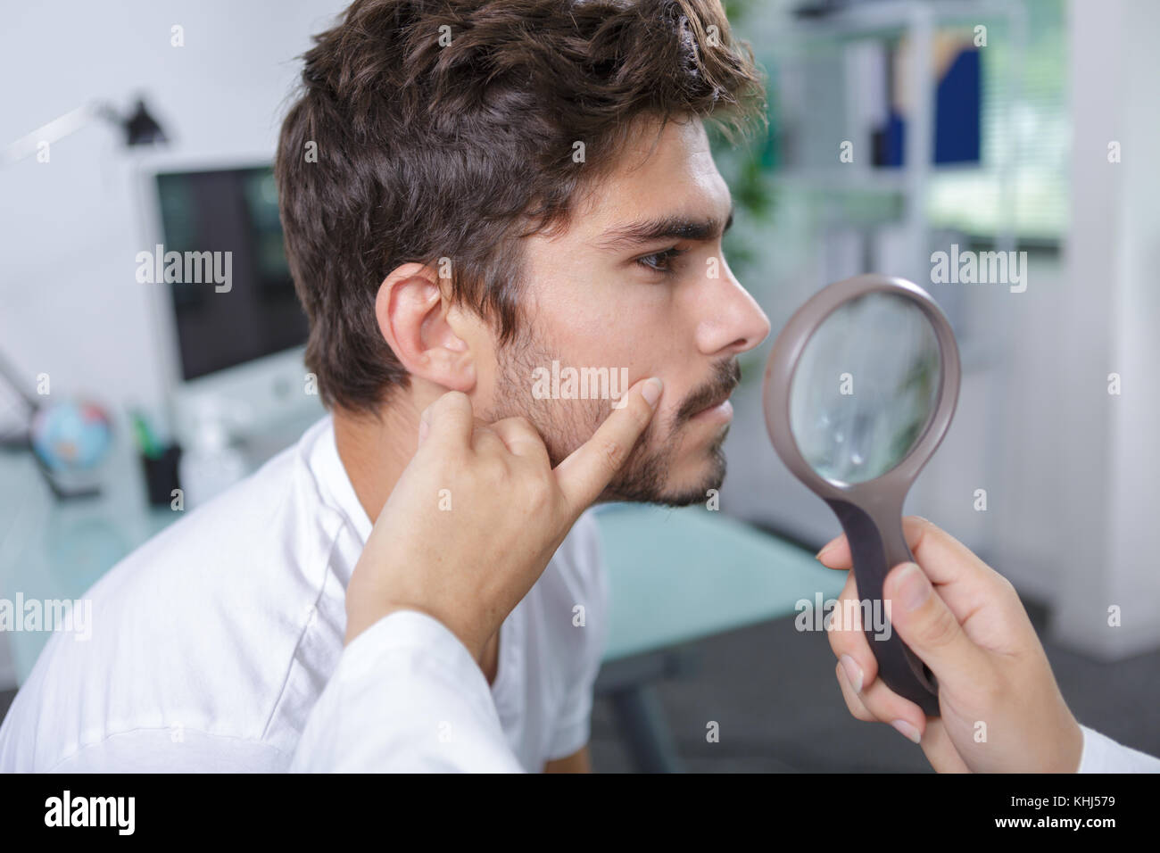 close-up of doctors hands checking mans moles Stock Photo - Alamy