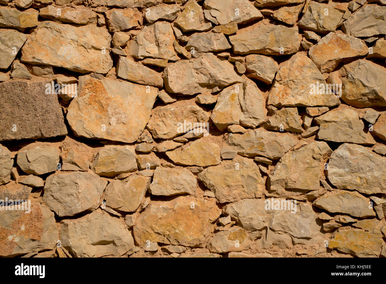 Stone wall in hot sun Stock Photo - Alamy