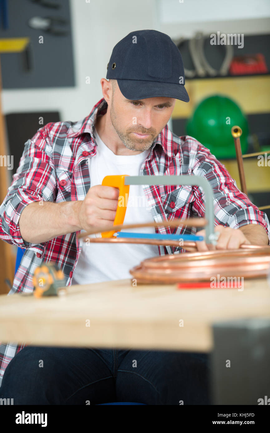 worker cutting copper pipe Stock Photo - Alamy