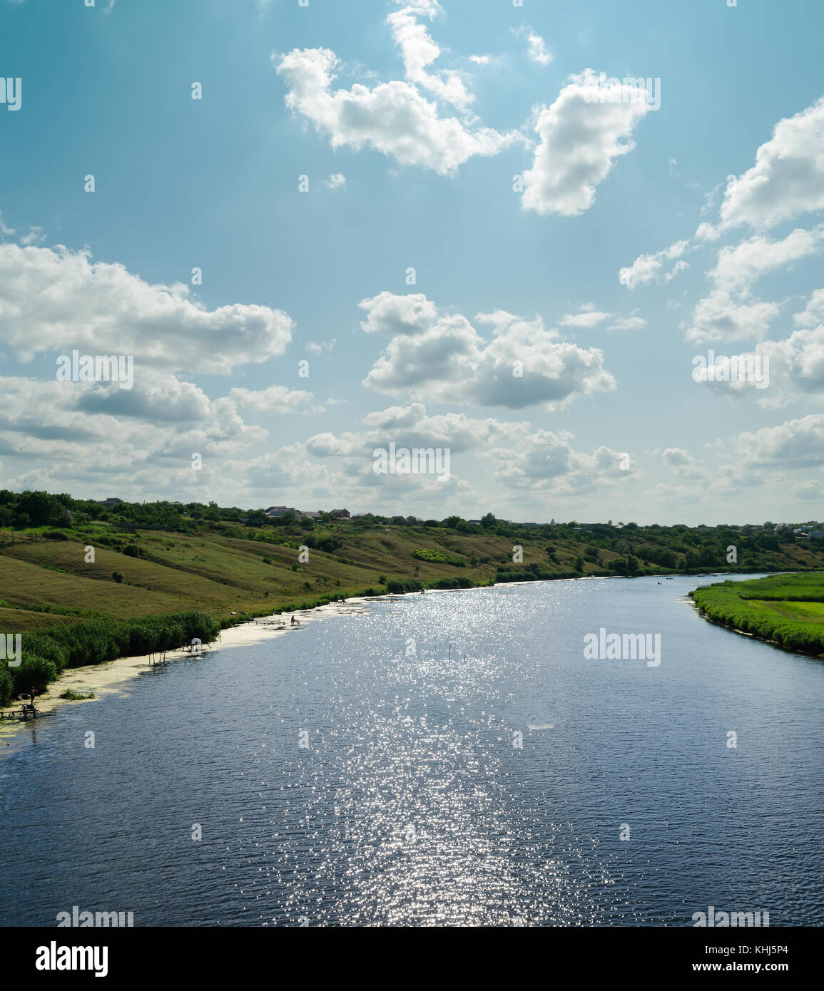 light clouds in blue sky over river with reflections Stock Photo - Alamy