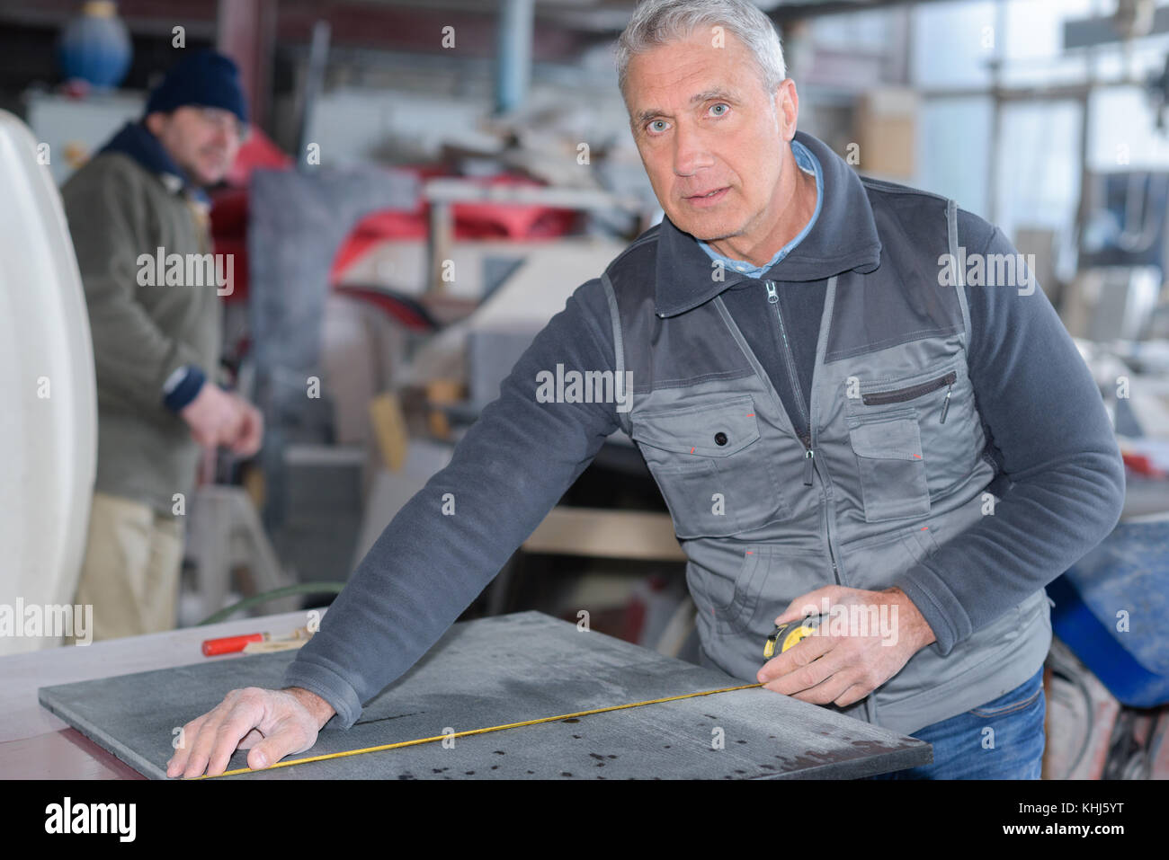 senior industrial worker in action on metal press machine Stock Photo ...