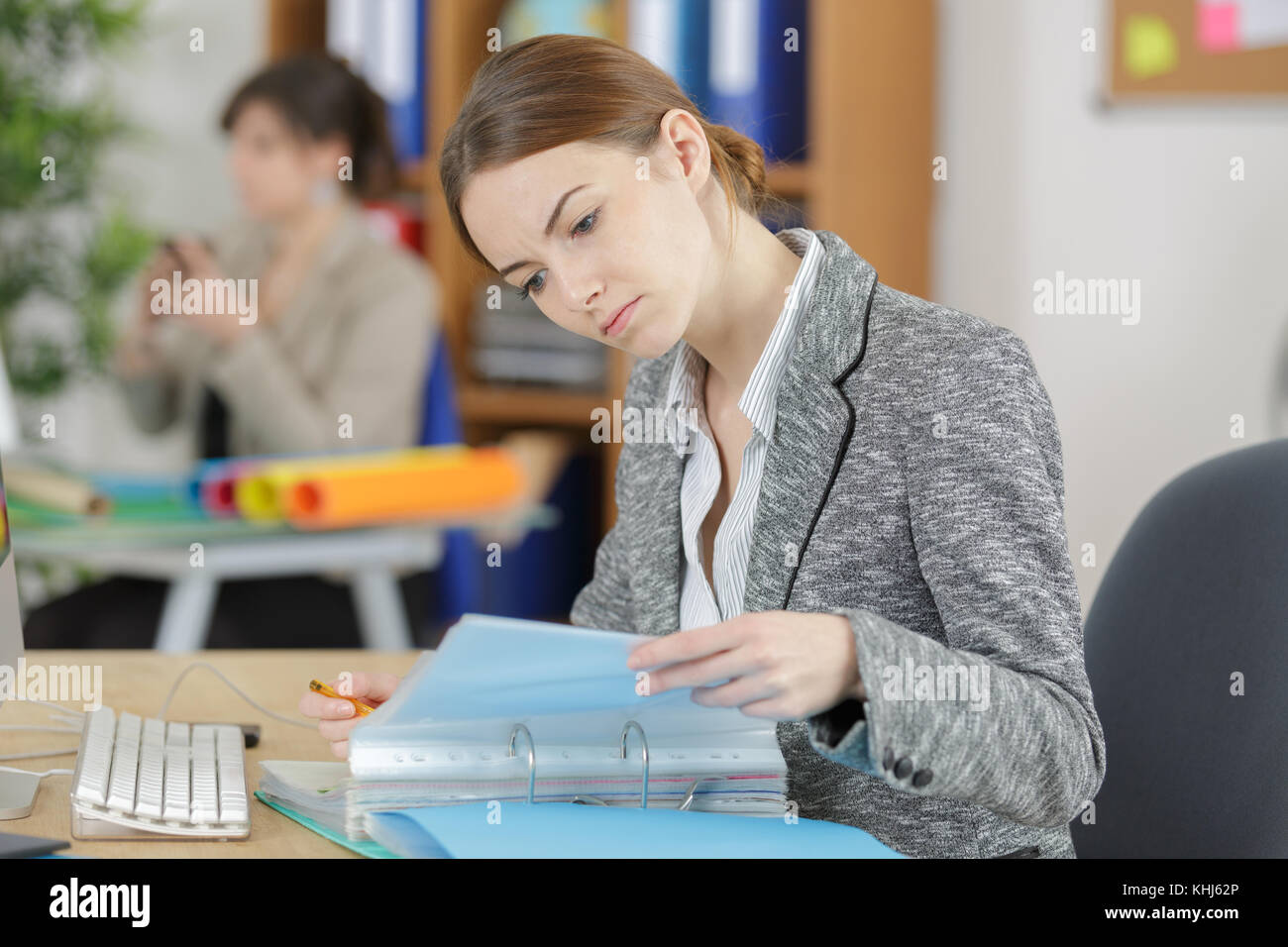 female assistant holds in hands a folders in an office Stock Photo - Alamy