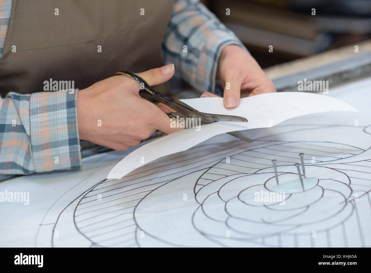 Artist cutting tracing paper template Stock Photo - Alamy