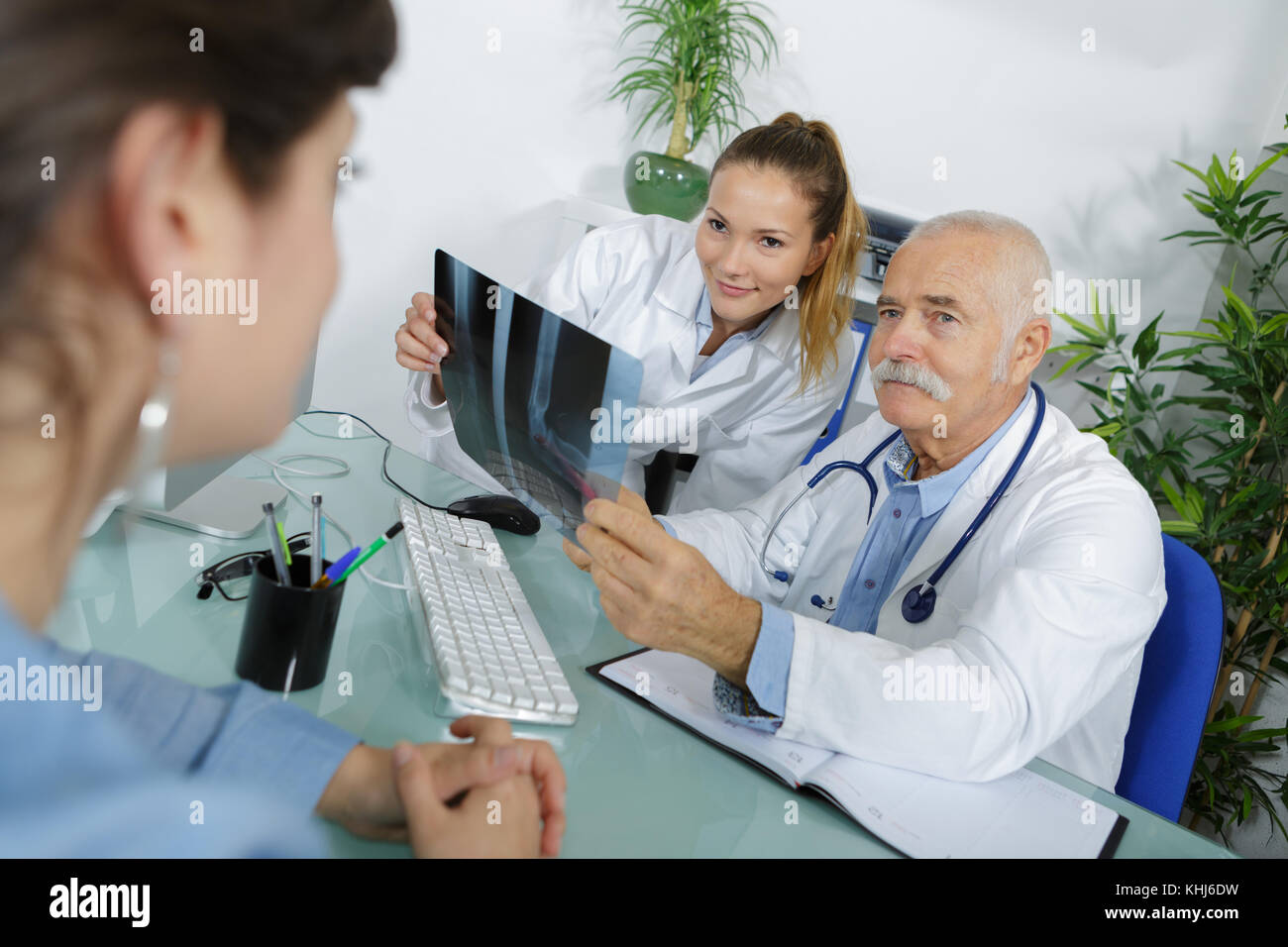 doctors checking xray with patient Stock Photo - Alamy