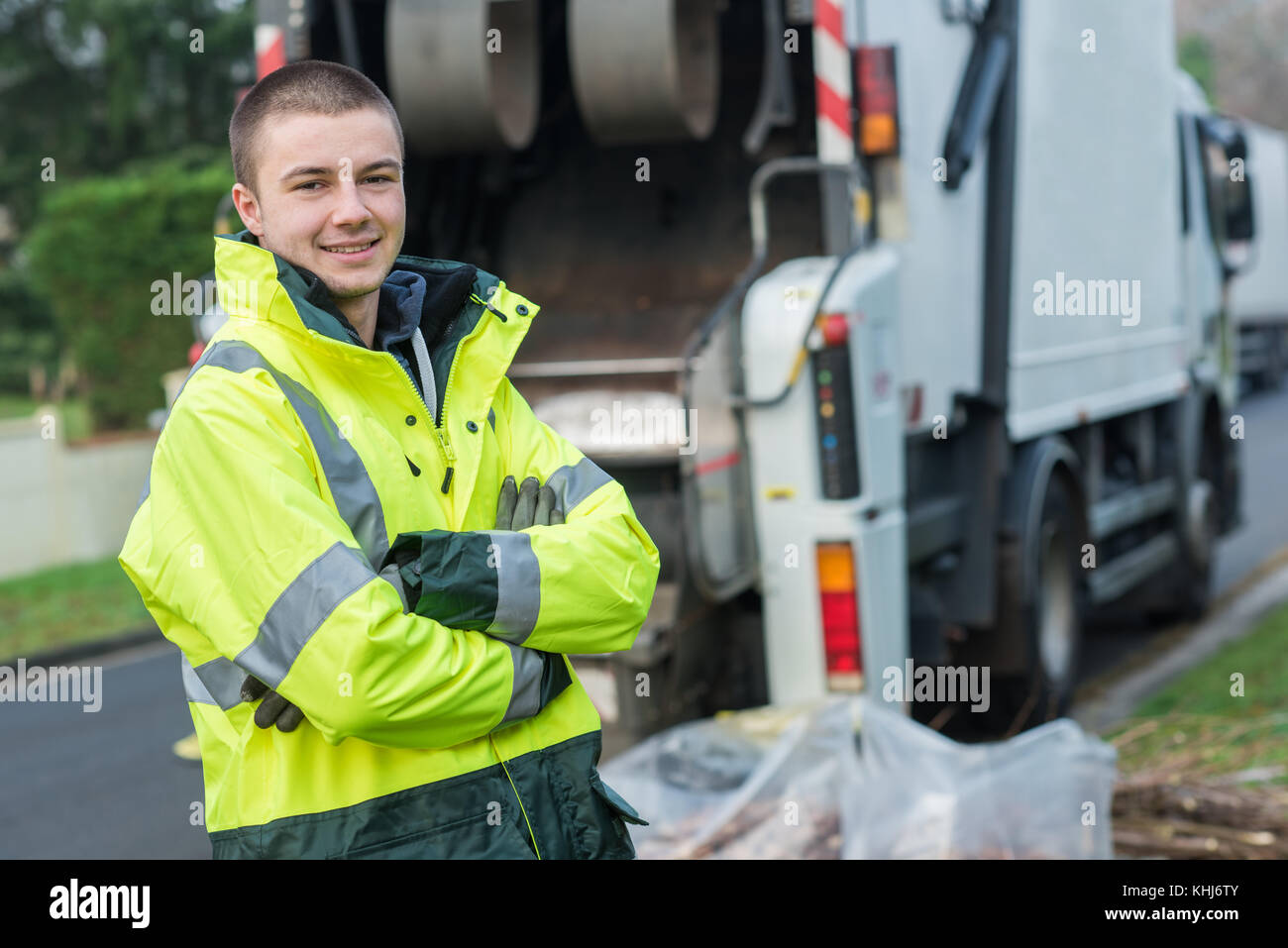 young garbage collector near truck Stock Photo - Alamy
