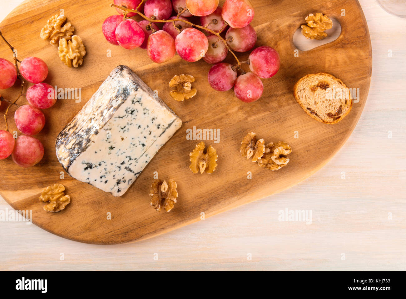 Blue cheese with grapes, nuts, and toasts, and copyspace Stock Photo ...