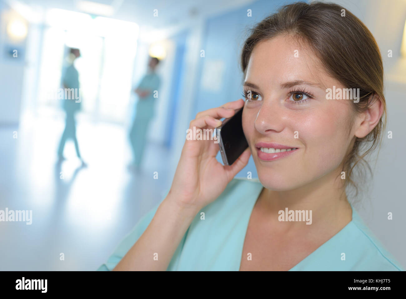 female surgeon using cell phone in hospital Stock Photo - Alamy