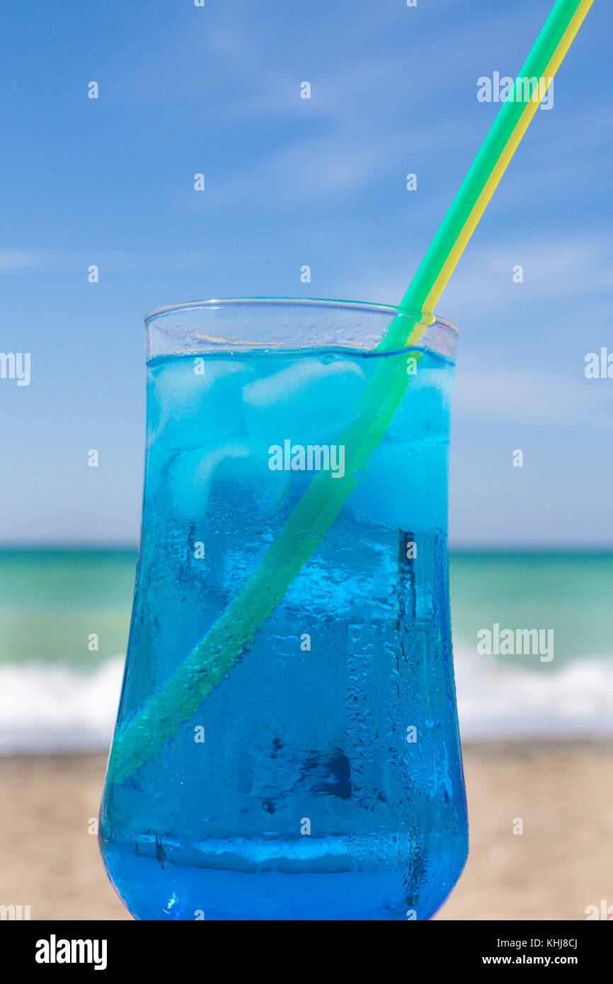 Blue alcoholic cocktail on the background of the sea Stock Photo - Alamy