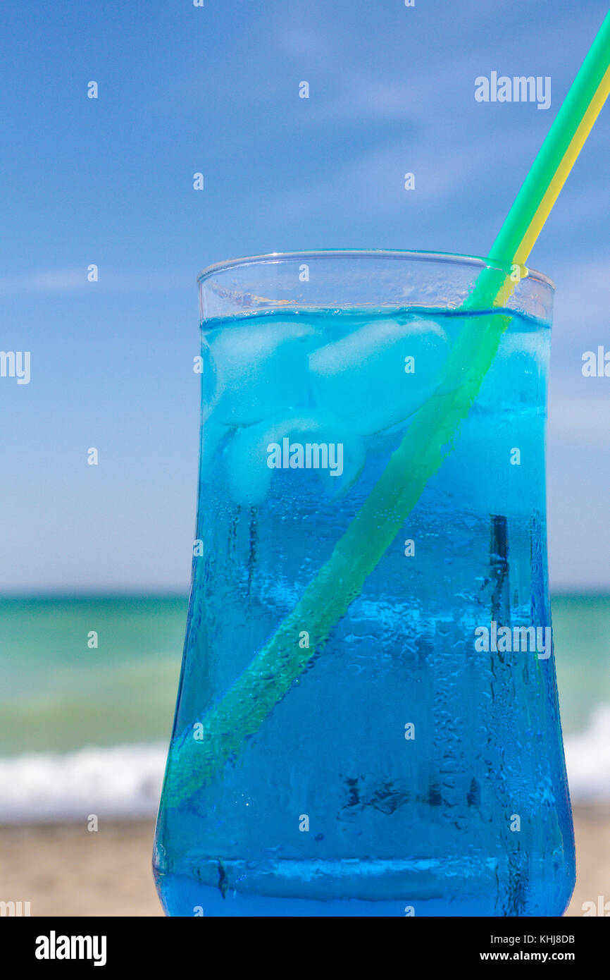 Blue alcoholic cocktail on the background of the sea Stock Photo - Alamy