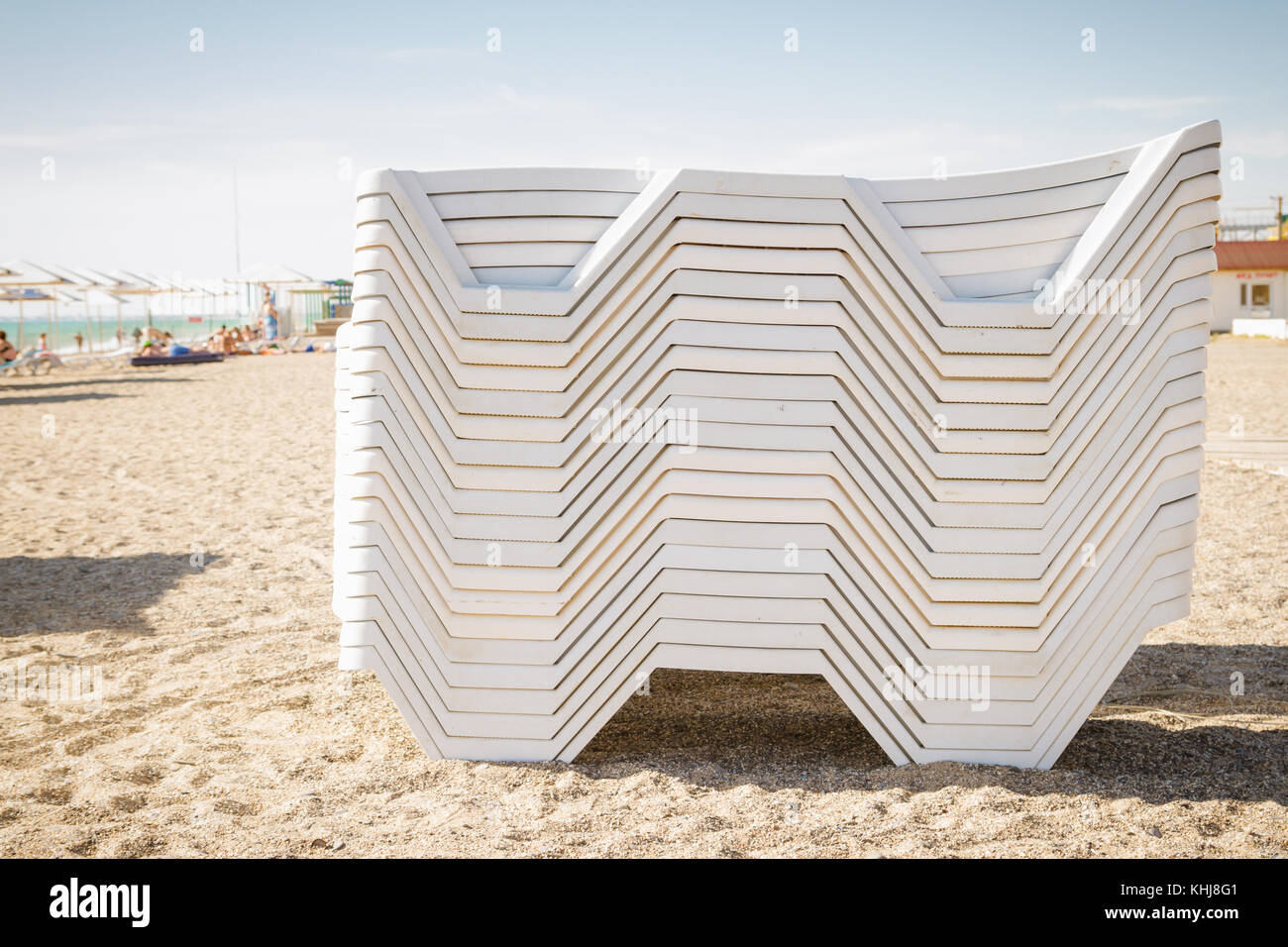 White stacked sun loungers on the beach Stock Photo - Alamy