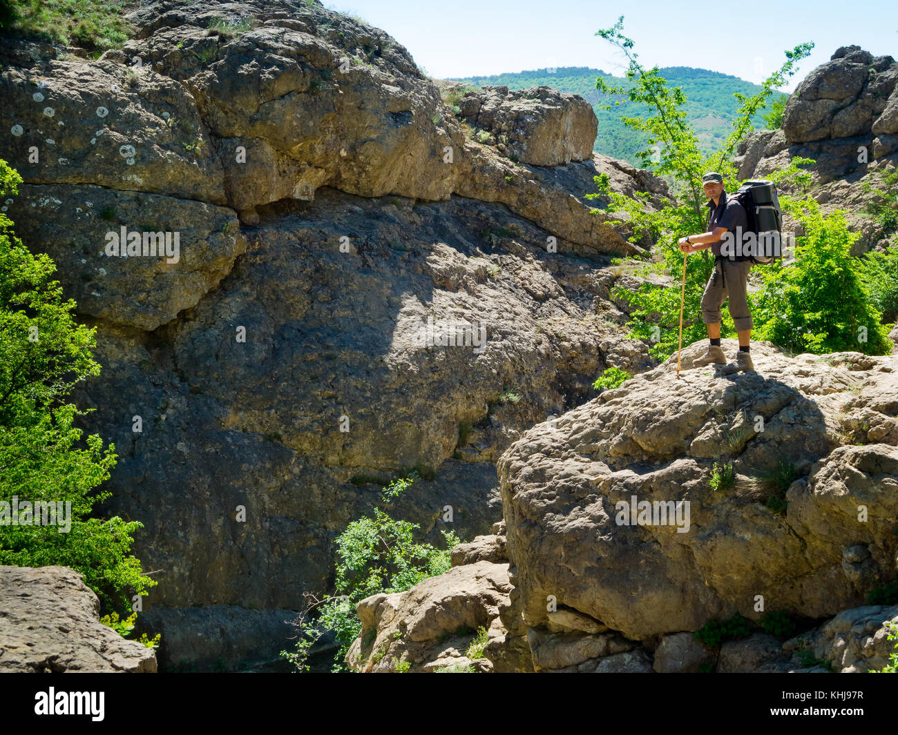 Hiker posing on the rocks Stock Photo - Alamy