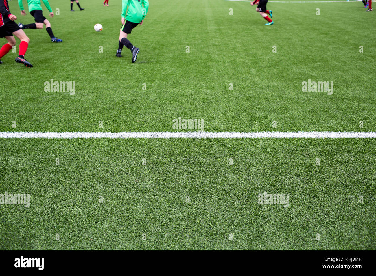 A new artificial sports pitch with white lines in the plastic grass ...