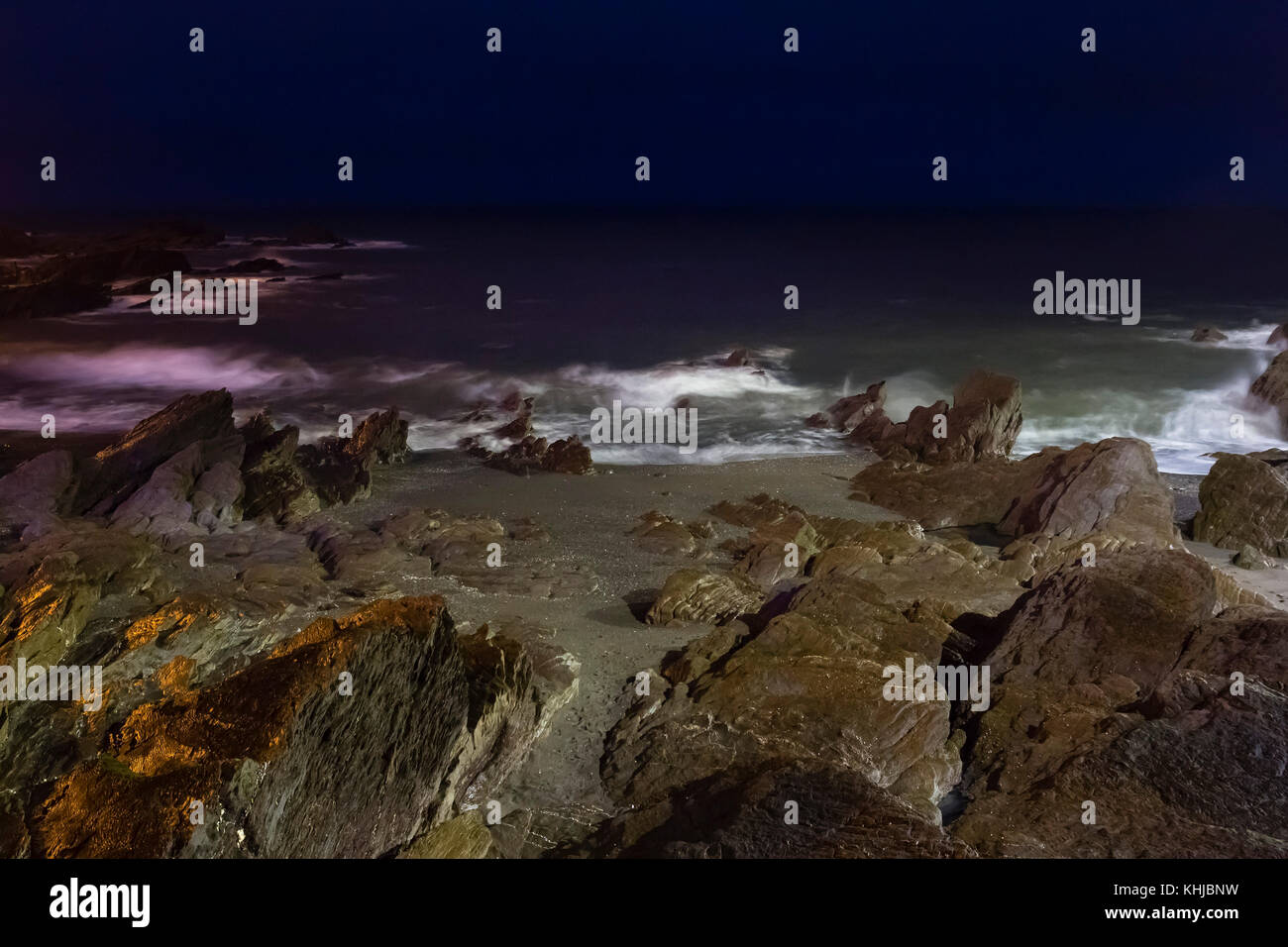 The north devon coast at Ilfracombe with a night time scene, lights on ...