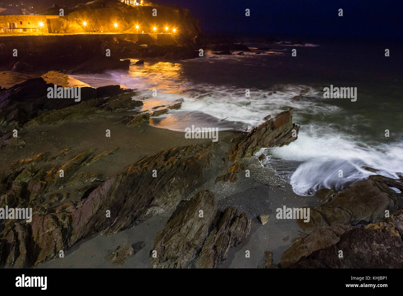 The north devon coast at Ilfracombe with a night time scene, lights on ...