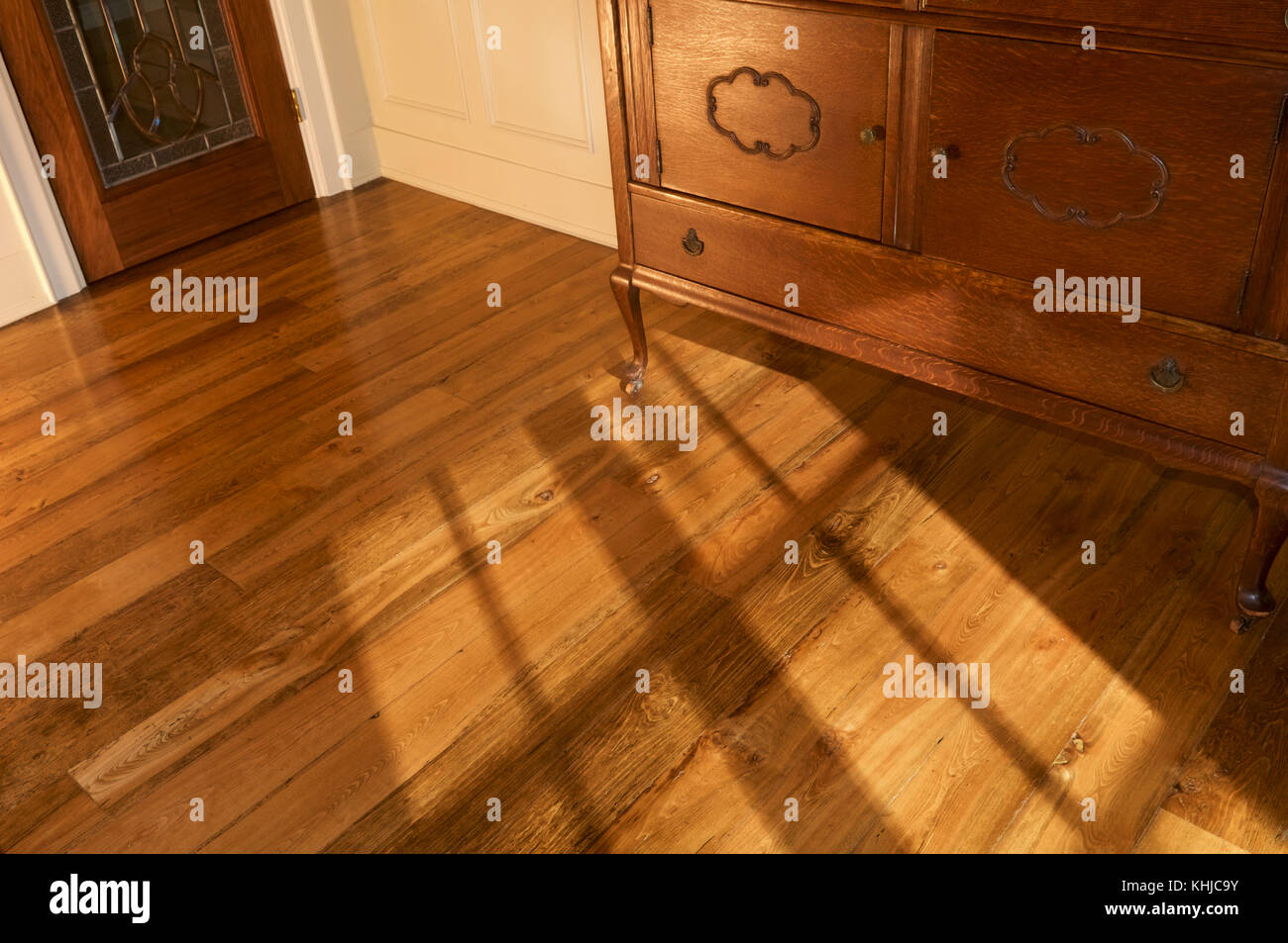 Morning light, in the shape of cast window frames, streams across a ...