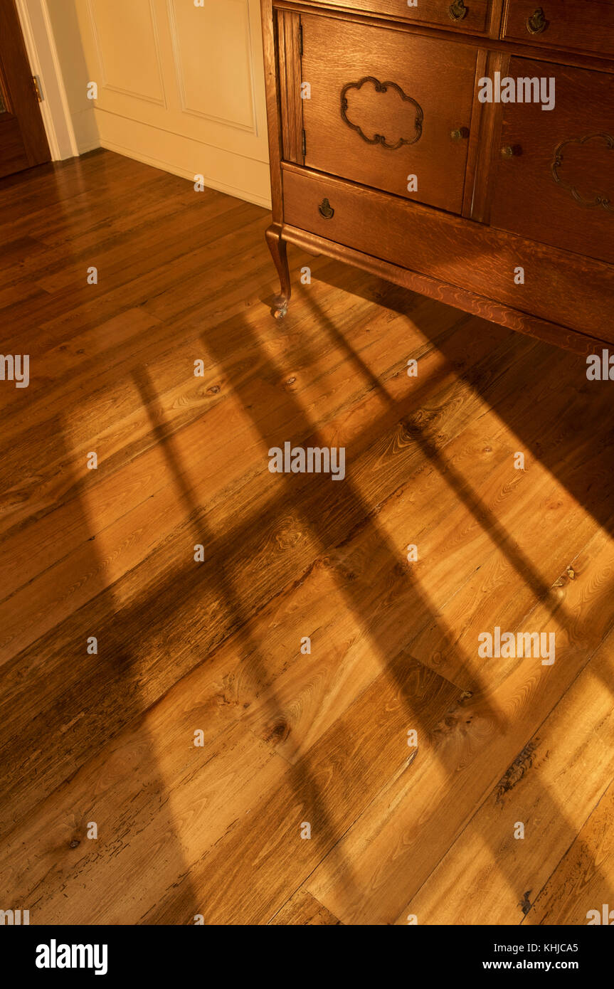Morning light, in the shape of cast window frames, streams across a ...