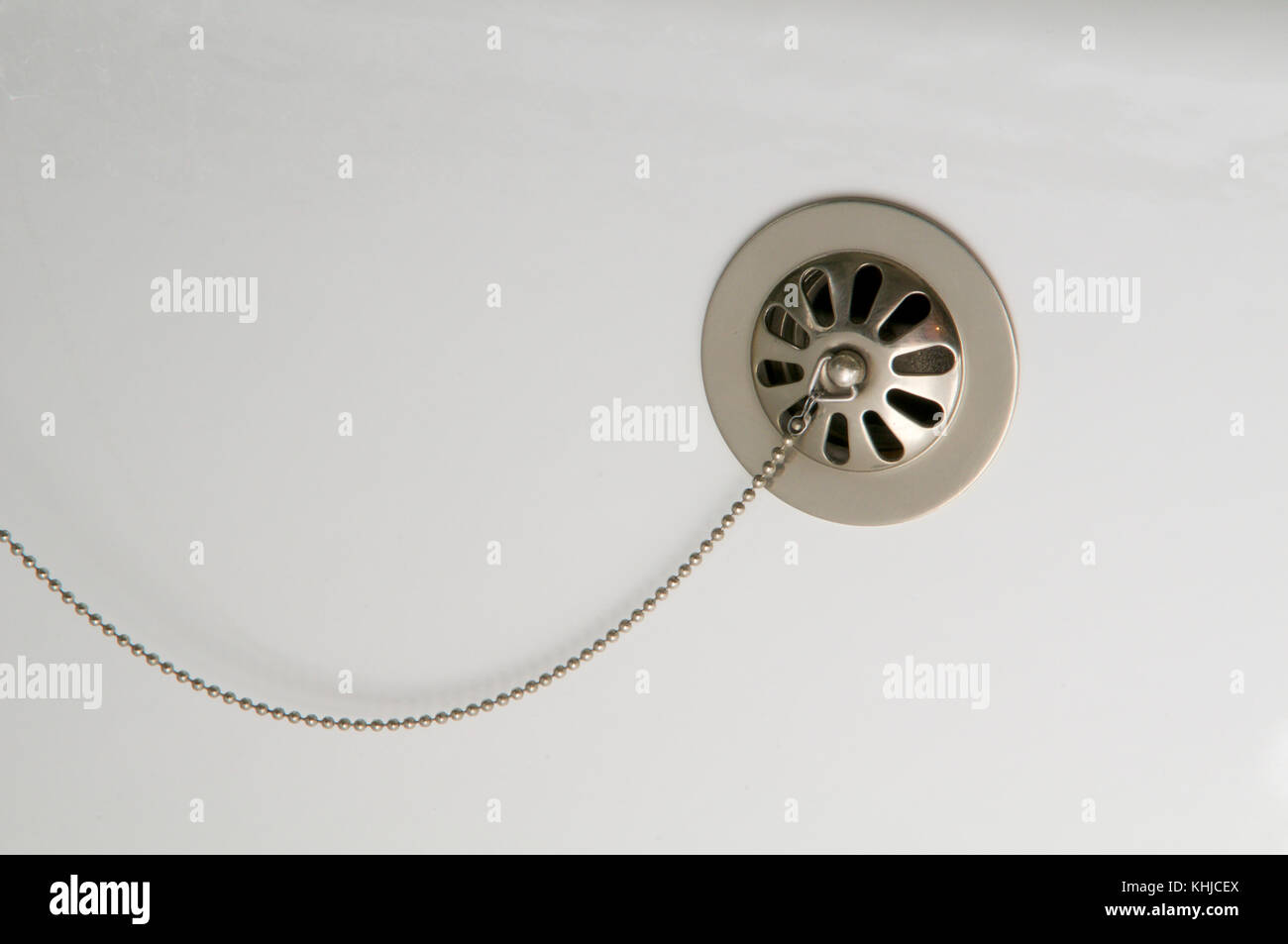 Overflow outlet and plug chain in an old claw footed bathtub Stock ...