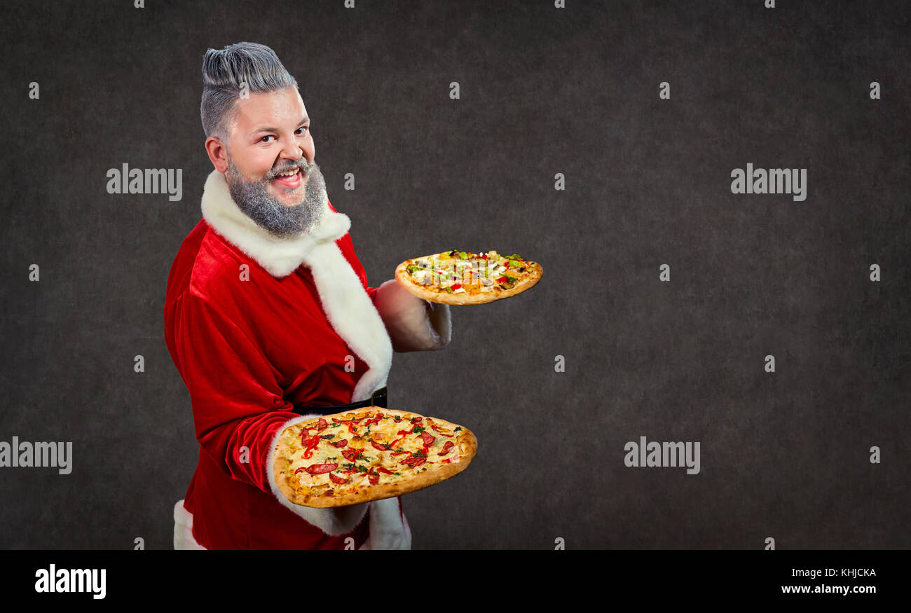 Santa Claus with pizza in hands Stock Photo - Alamy