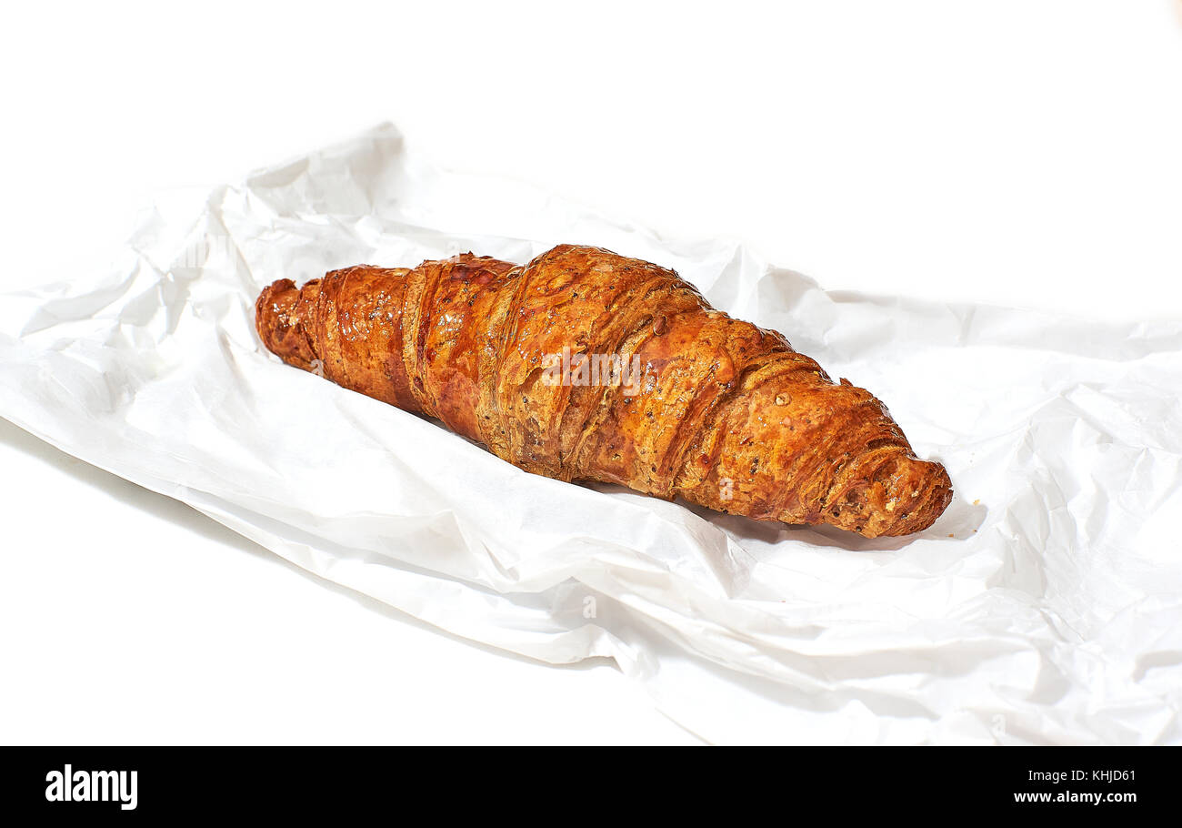 Croissant on a grocery white paper bag, european style Stock Photo - Alamy
