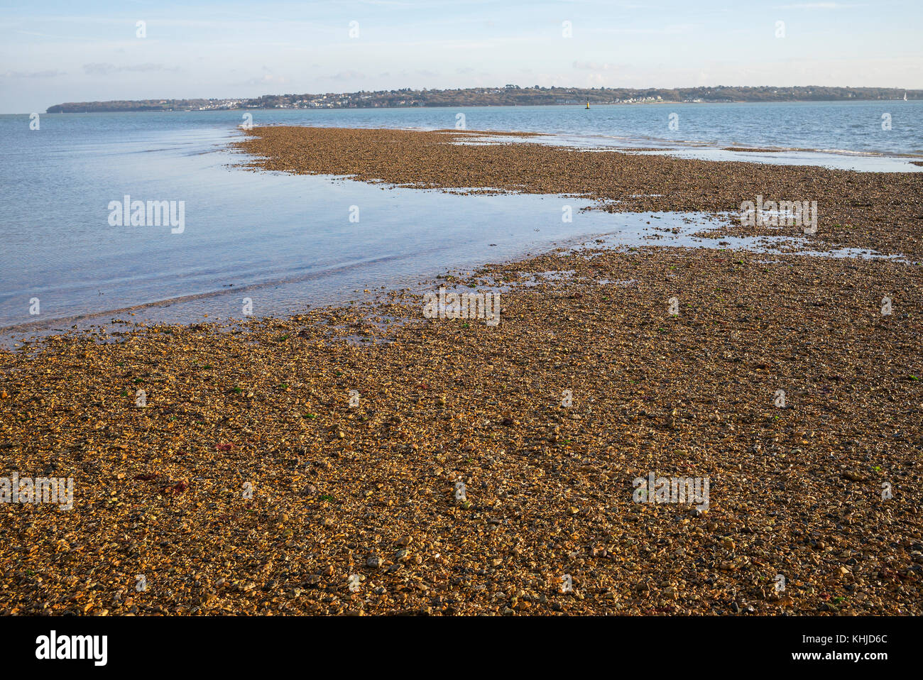 A shingle bar extending into the sea at low tide over looking The ...