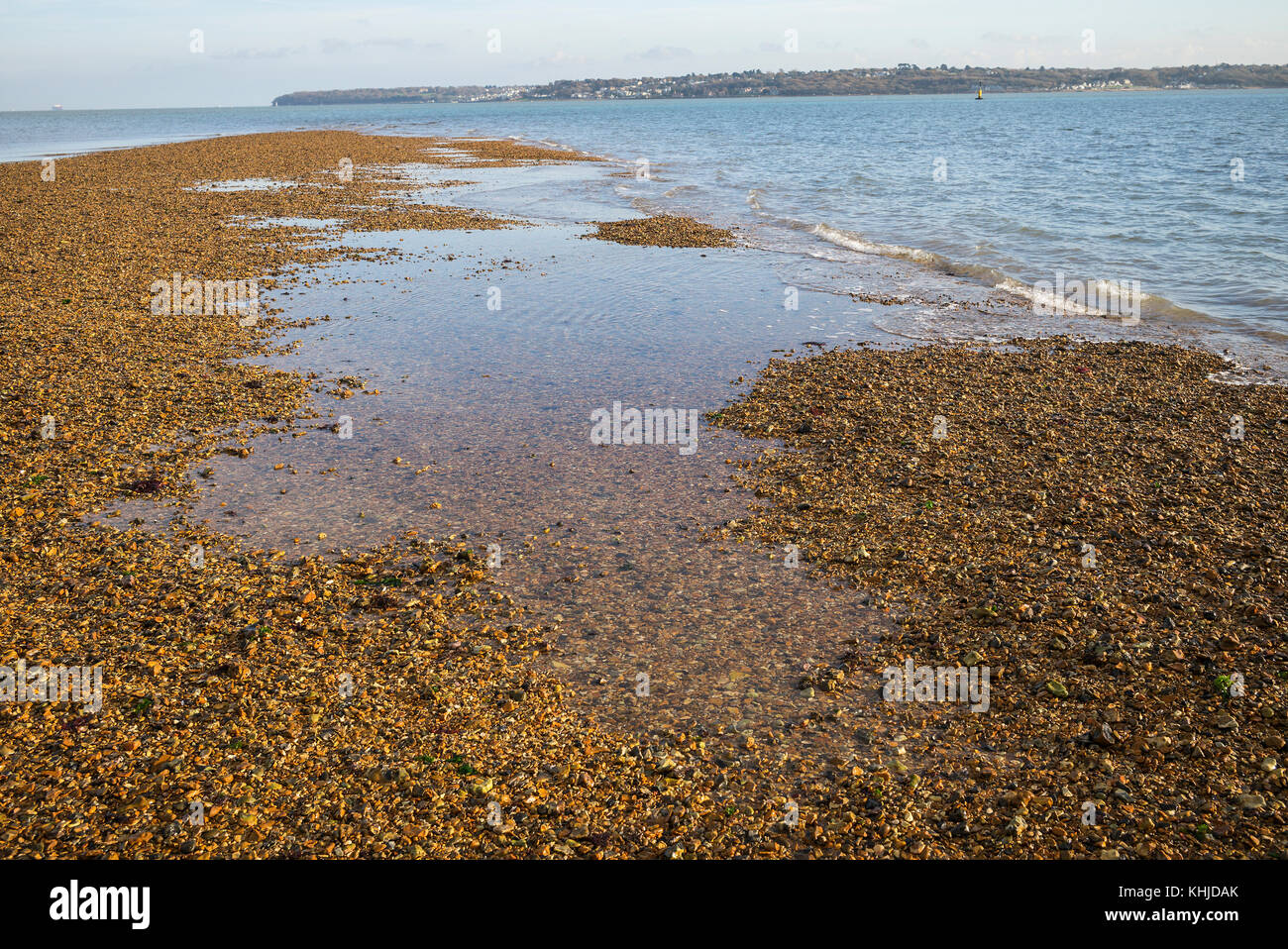 A shingle bar extending into the sea at low tide over looking The ...