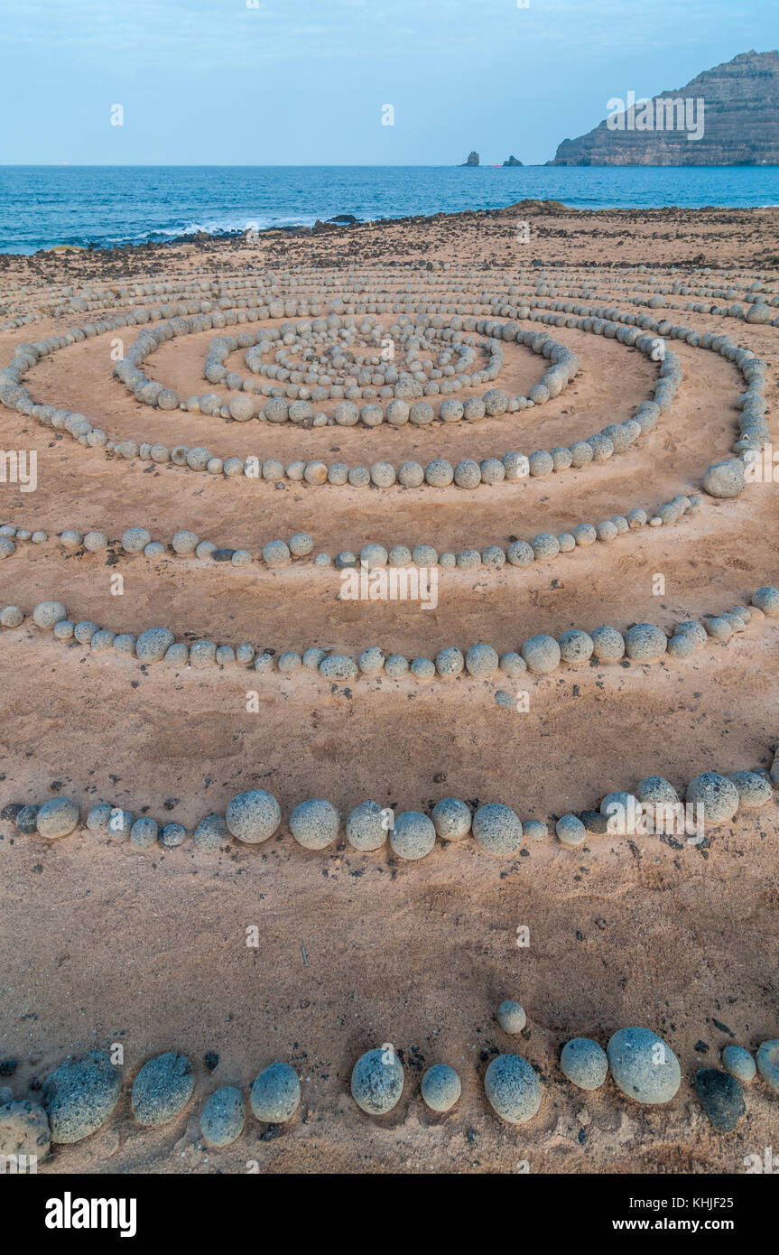 completely circular stones on the ground forming a spiral near the ...