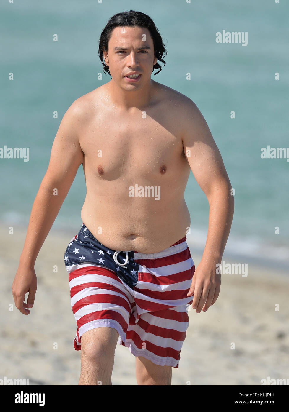 MIAMI BEACH, FL - MAY 14: Actor Jon Bass goes for a swim wearing ...