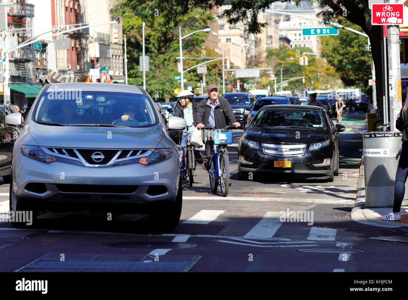 Bicyclists veer into a car travel lane to avoid a car in the middle of ...