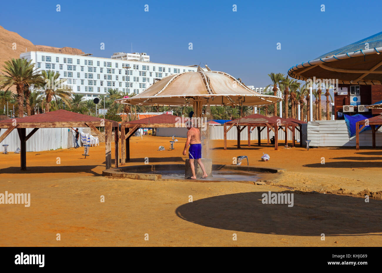 Man is washed in the shower on the beach of Dead sea, Israel Stock ...
