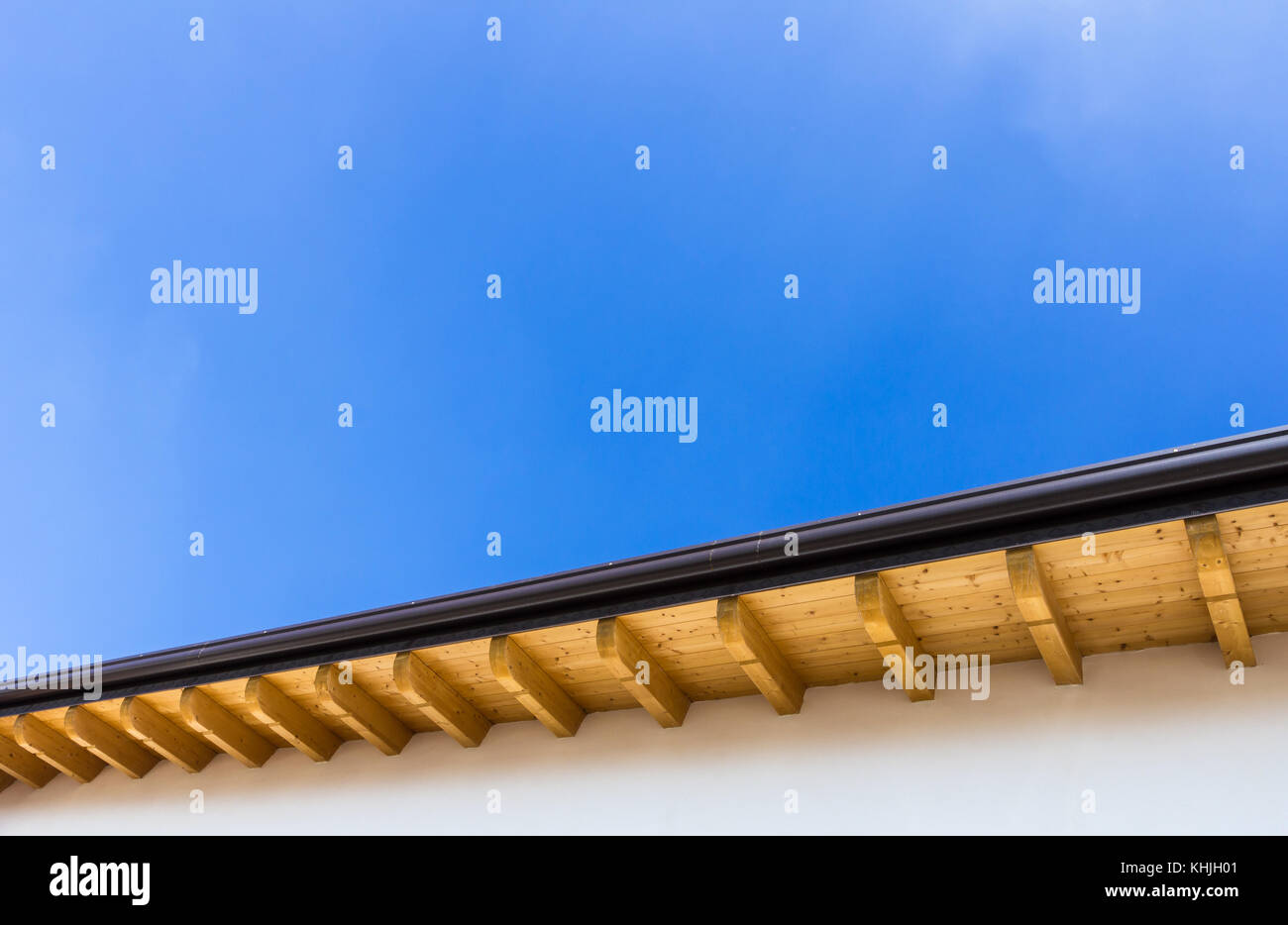 Low angle view of new house with wooden roof and gutter against clear ...