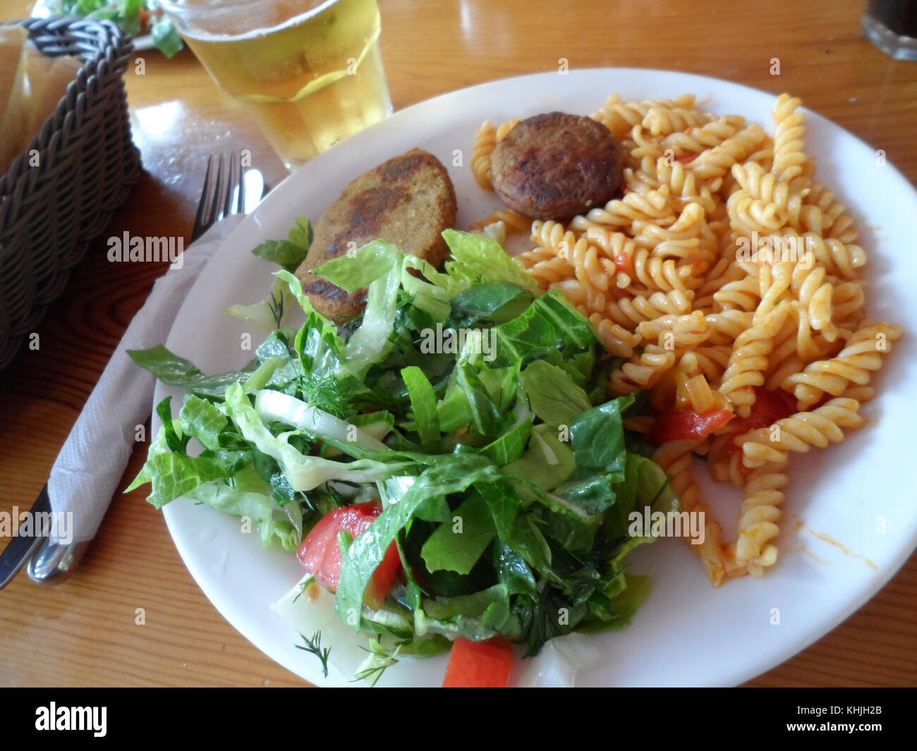 Turkish lunch of Fusilli pasta, Chicken burger, Lamb pate and salad on ...