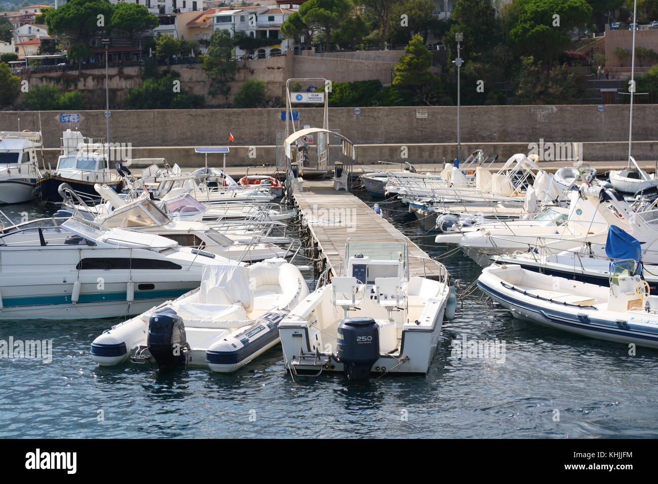 Several small powerboats in the port at a pier Stock Photo - Alamy