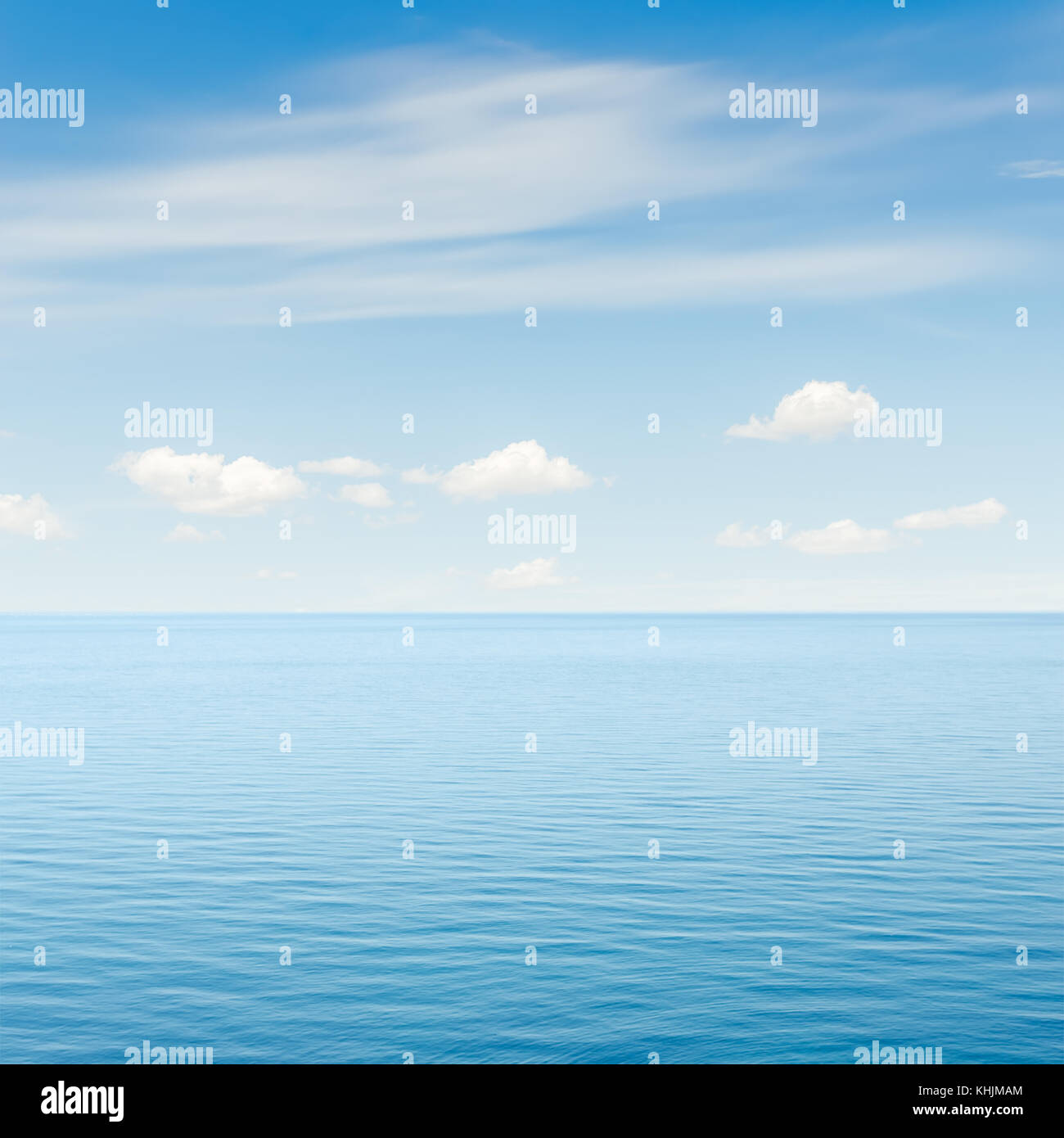 blue sea and sky with clouds over it Stock Photo - Alamy