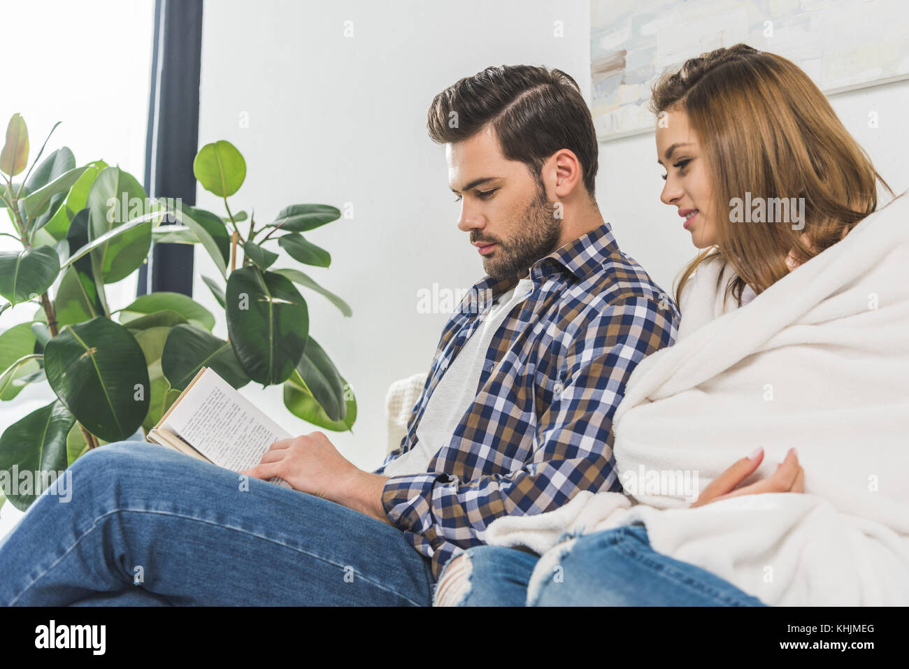 attractive couple reading book Stock Photo - Alamy